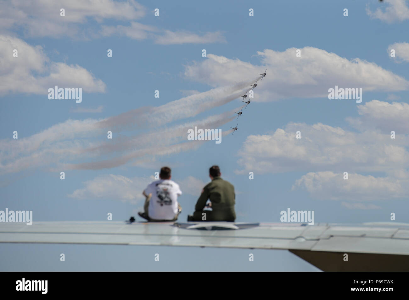 Two spectators watch the delta bottom up pass during the Air Commandos ...