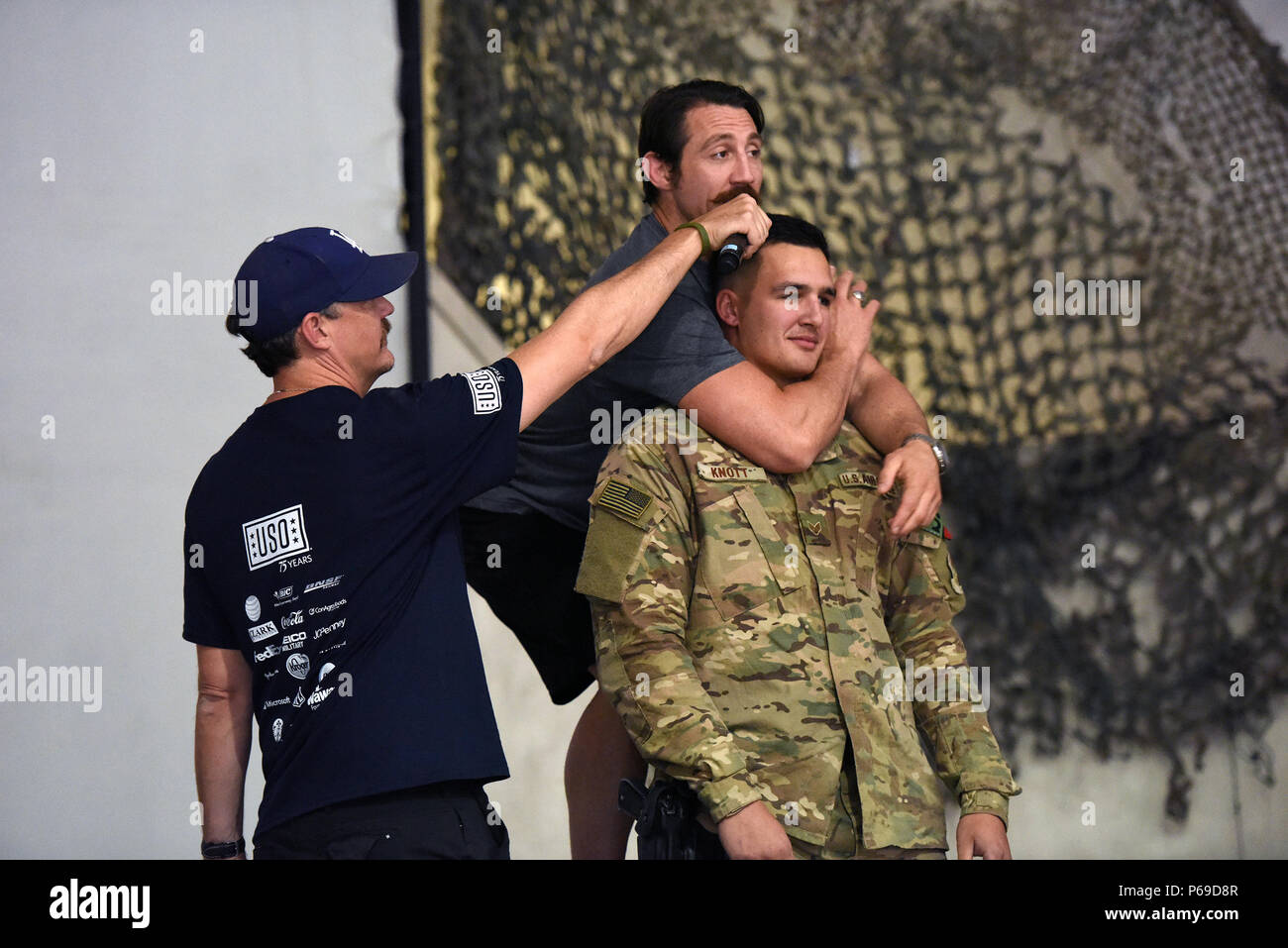 UFC fighter Tim Kennedy demonstrates a choke hold on a soldier as actor ...