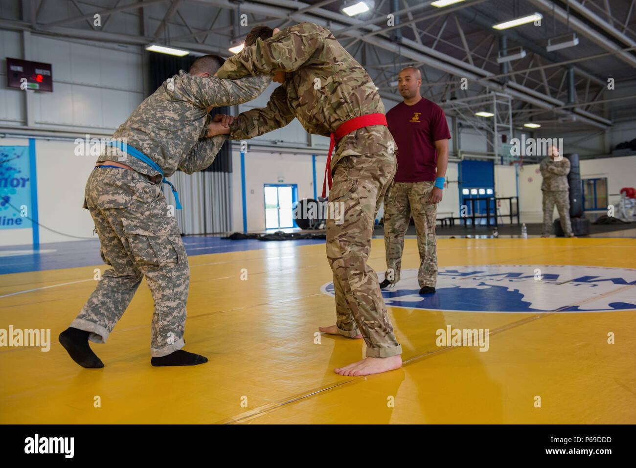 A U.S. Soldier and a member of the British King's Royal Hussars grapple ...