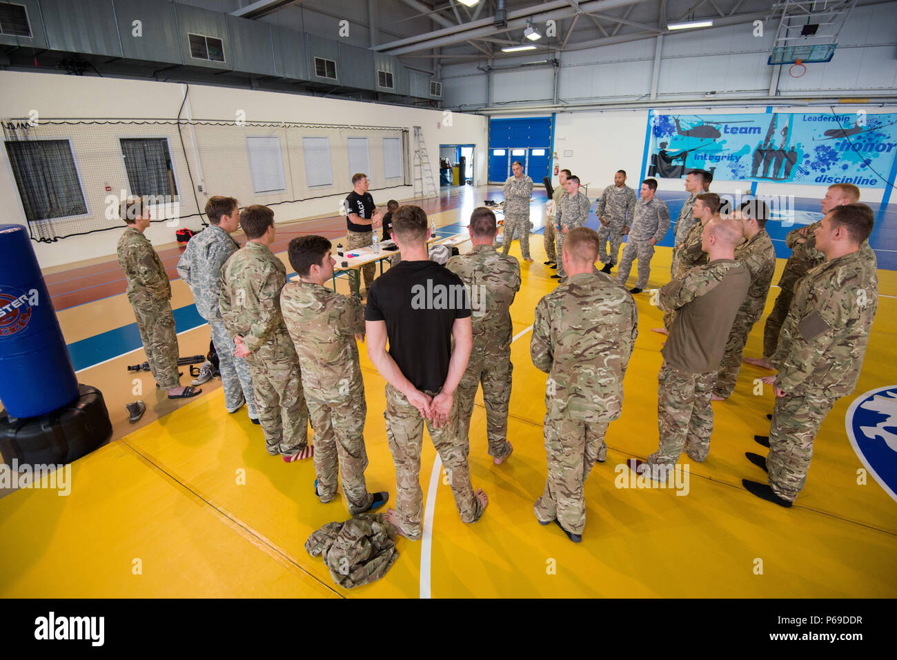 U.S. Soldiers and members of the British King's Royal Hussars listen to ...