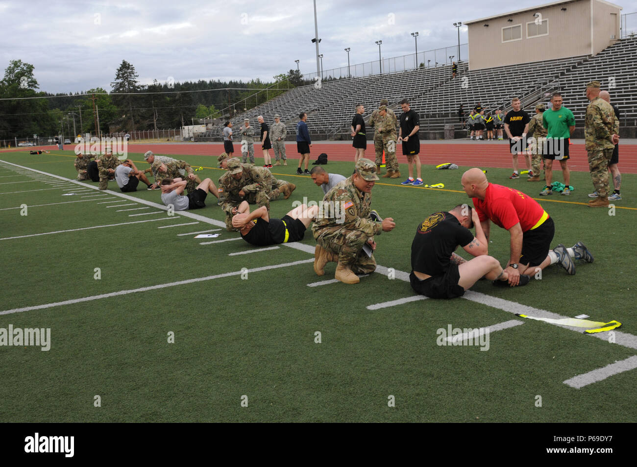 Noncommissioned officers and Soldiers conduct sit-ups during the Army ...