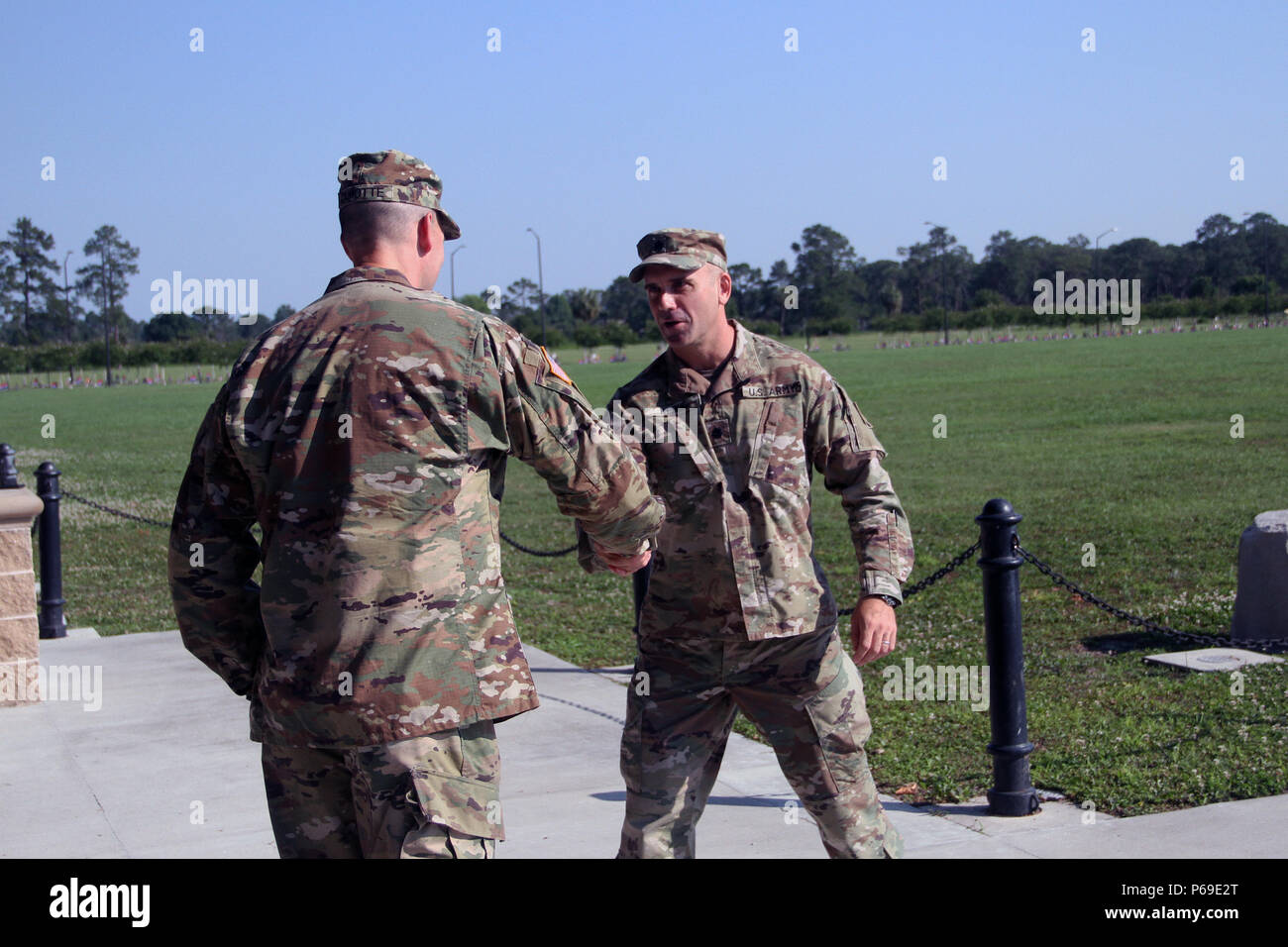 Lt. Col. Brandon Klink (right), outgoing commander, shakes hands with ...