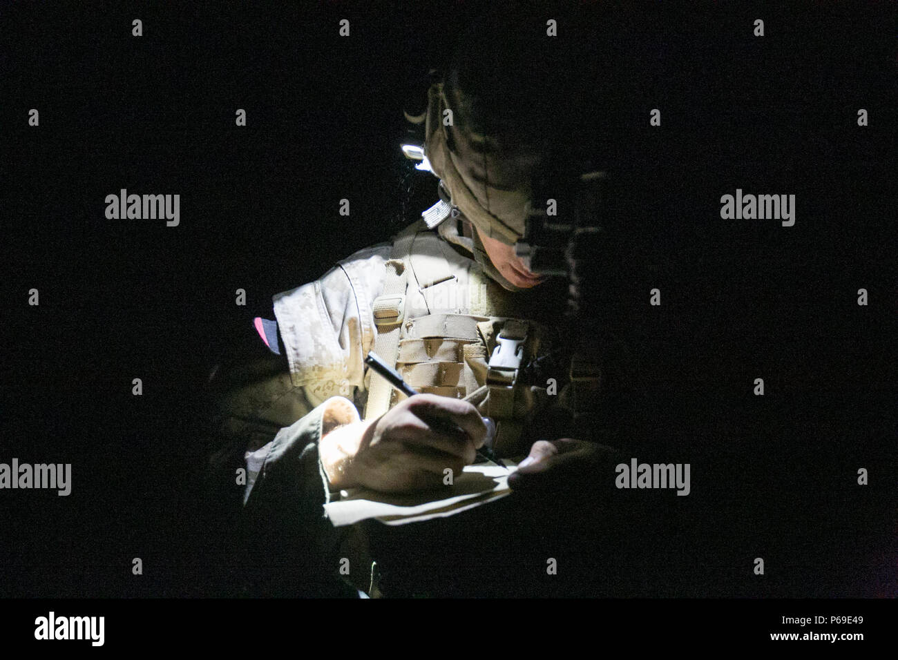 A Navy corpsman fills out a tactical combat casualty care card after ...