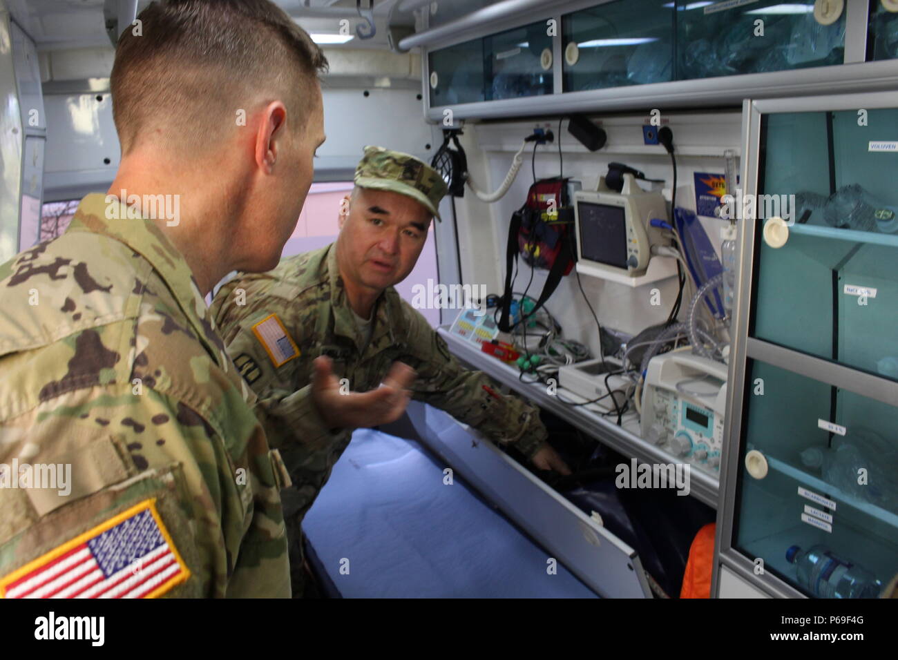 U.S. Army Sgt. 1st Class Peter Sutherland, right, discusses differences ...