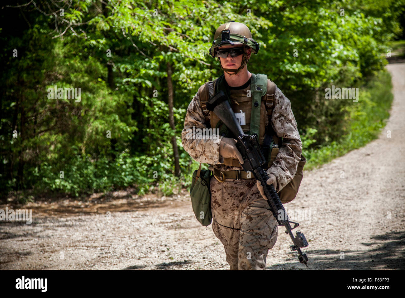 A U.S. Marine attending the Military Police Basic Course, conducts a ...