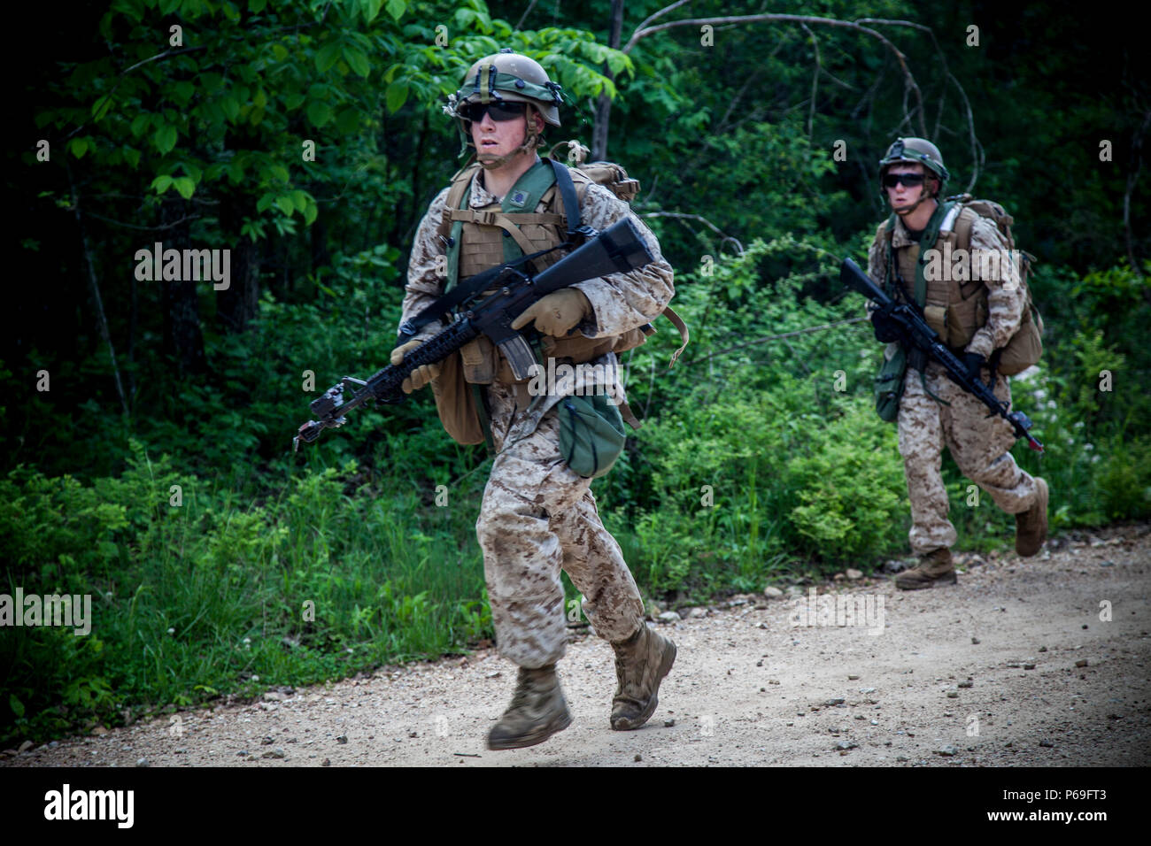 U.S. Marines attending the Military Police Basic Course, run to assume ...