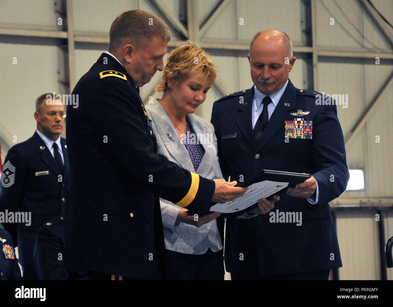 Maj. Gen. Timothy A. Reisch presents Dawn Jamison, wife of Brig. Gen ...