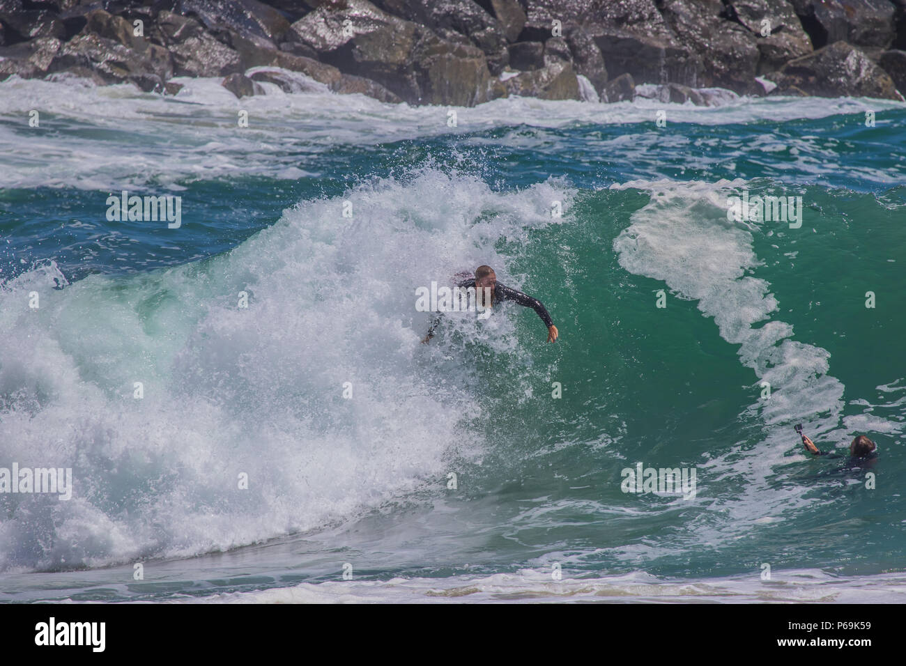 A photographer captures Bodysurfer riding a wave at the Wedge world ...