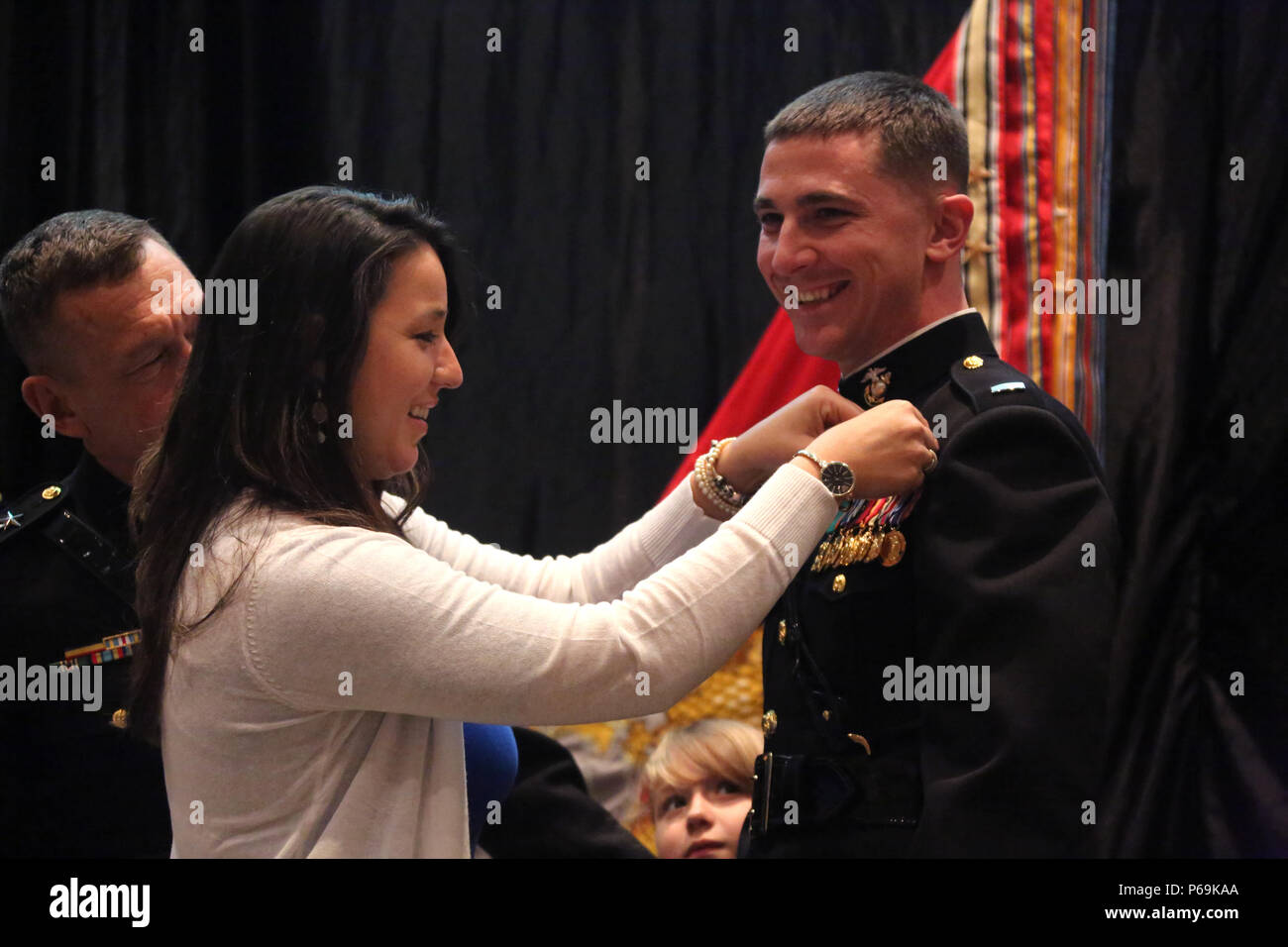A Marine Corps Aviator Is Pinned By His Wife During A Winging Ceremony a-marine-corps-aviator-is-pinned-by-his-wife-during-a-winging-ceremony