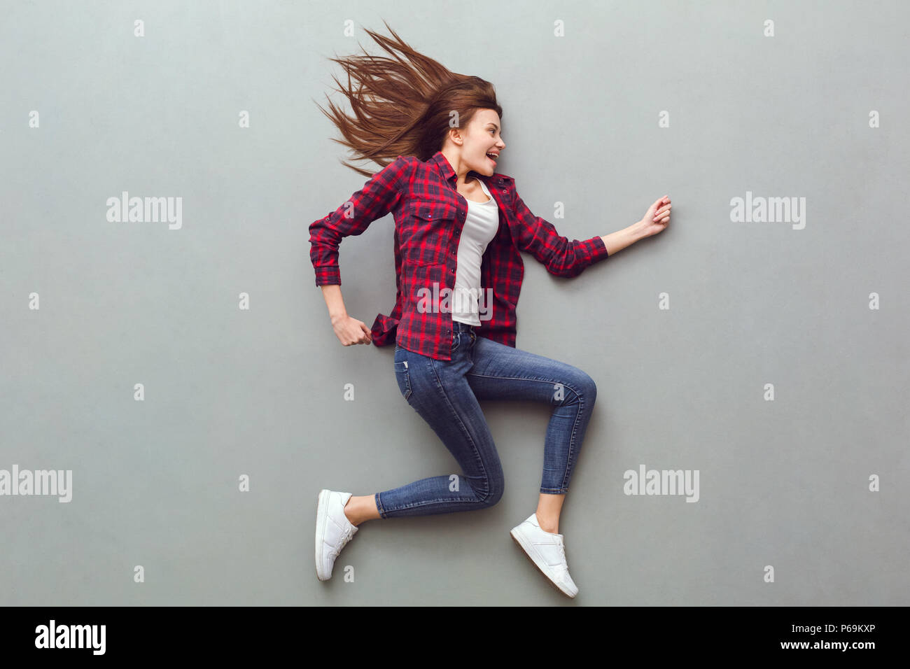 Young woman top view isolated on grey running active Stock Photo - Alamy