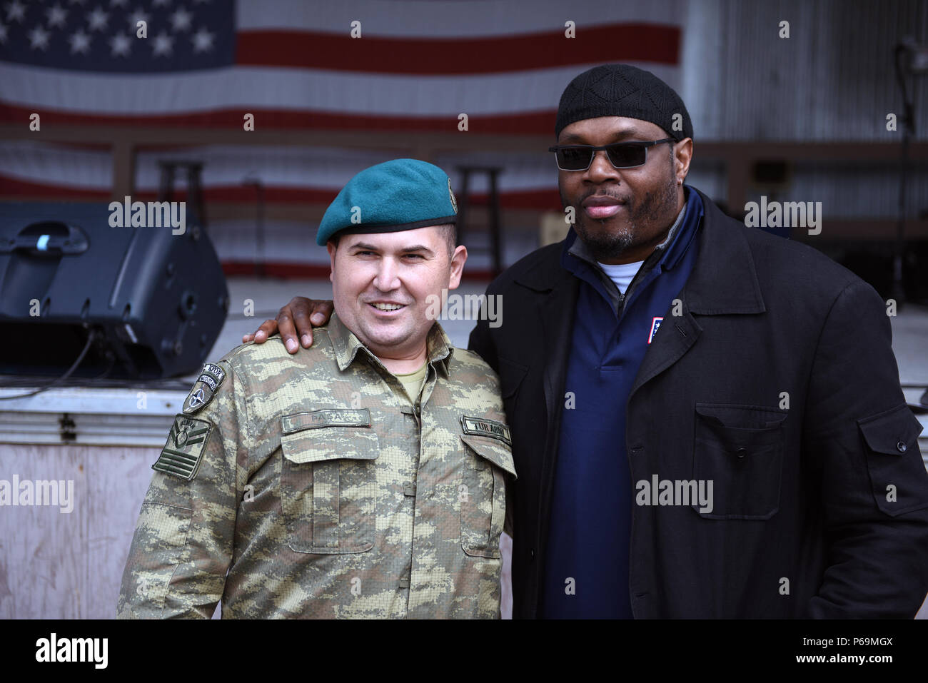 Former NBA player Sam Perkins with a soldier from an international ...