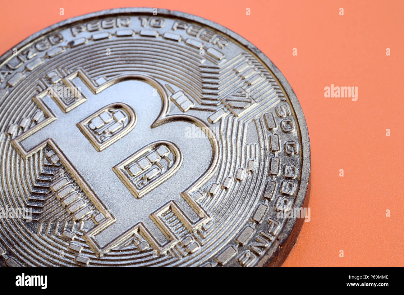 Chocolate product in the form of physical bitcoin lies on an orange ...