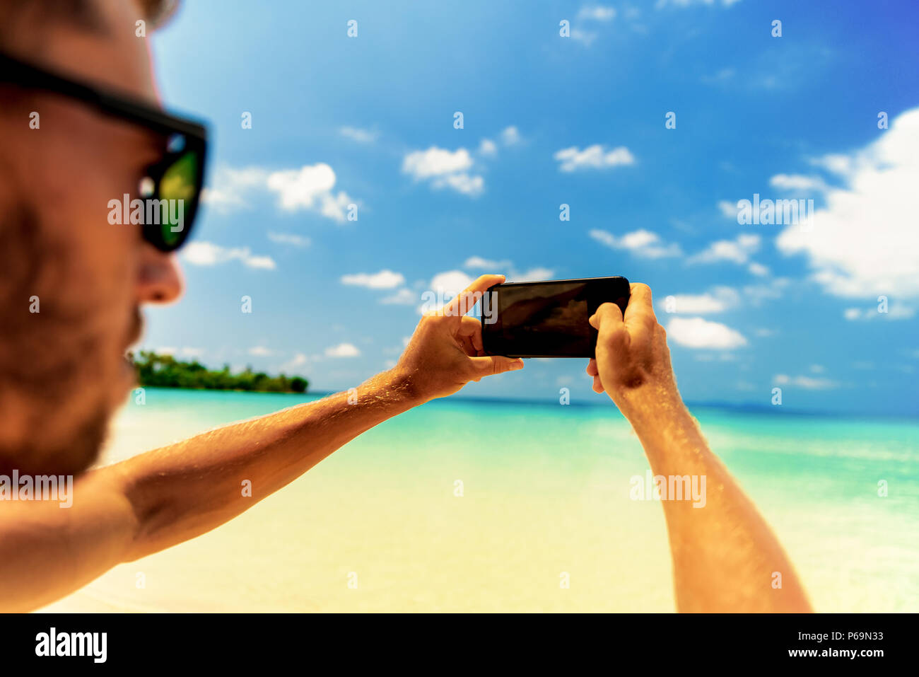 first eye view people using smart phone, cellphone on the beach on ...