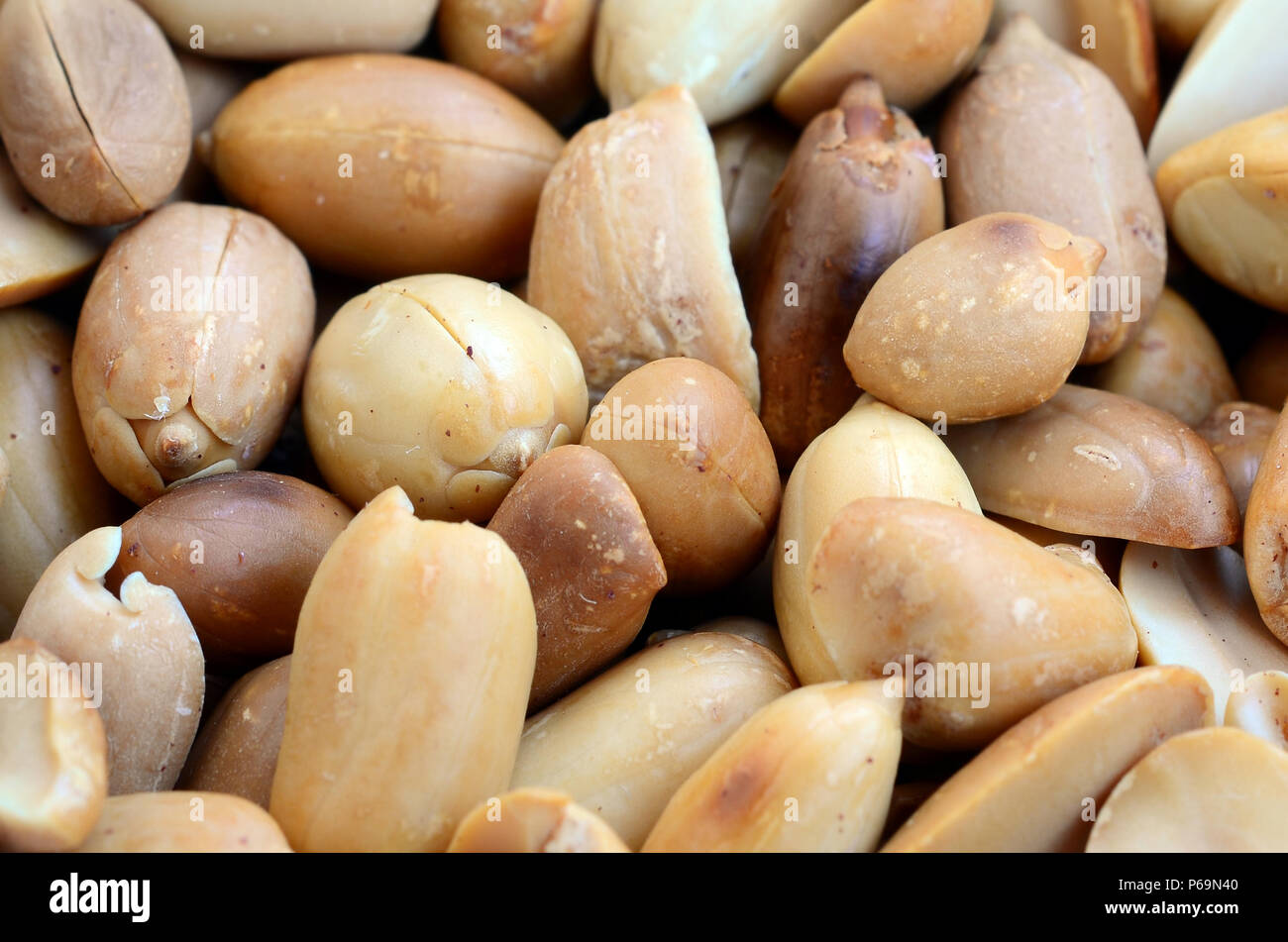 Peanut. A lot of small yellow nuts without peel. Background texture ...