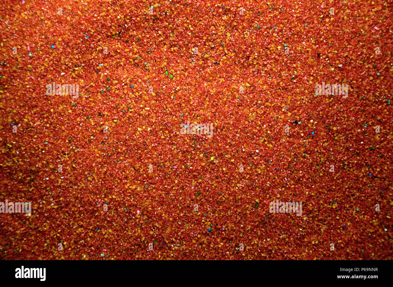 Texture of a colored granular sand close up. Red grains Stock Photo - Alamy