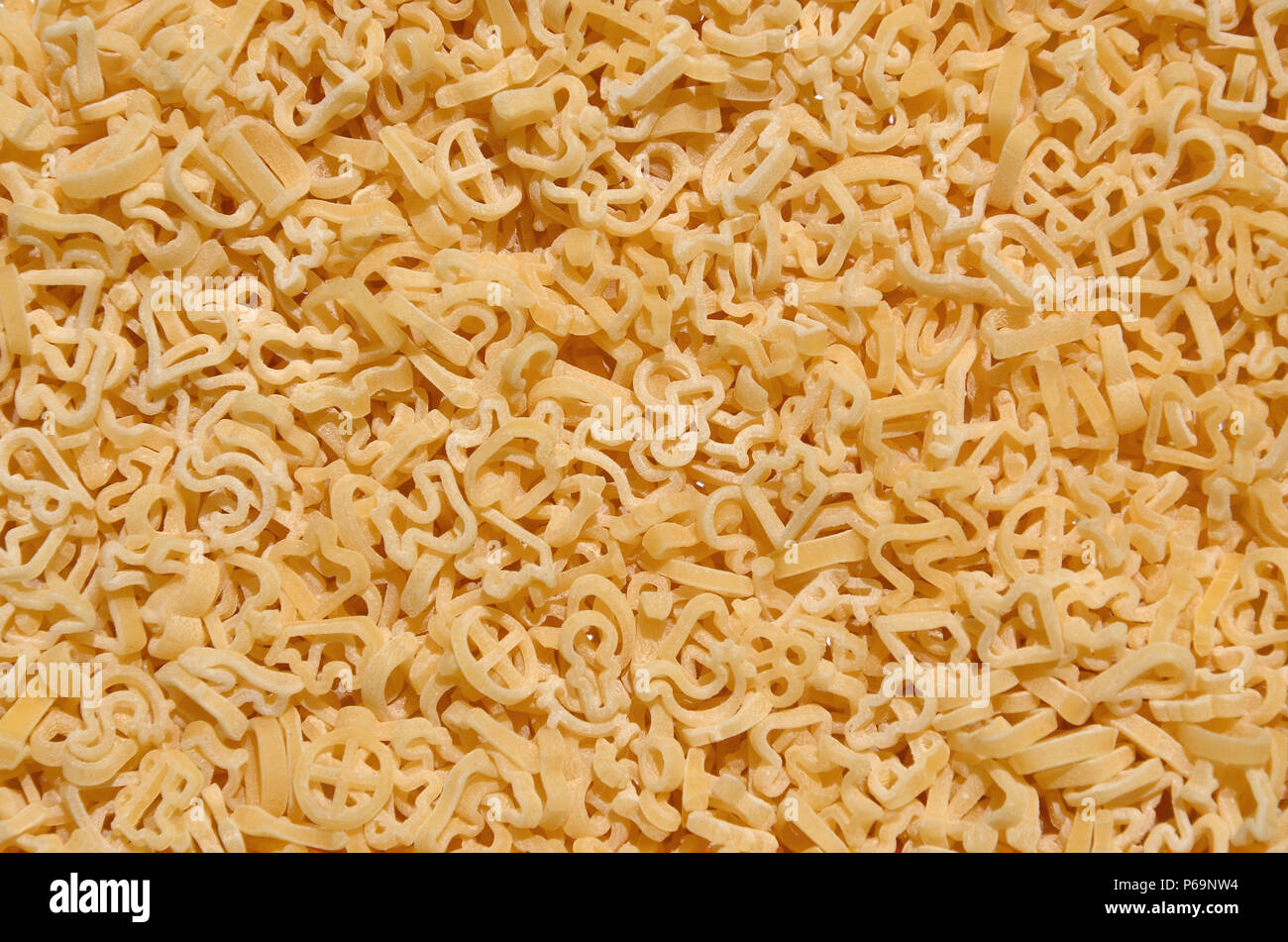 Texture of a lot of curly raw yellow pasta Stock Photo - Alamy
