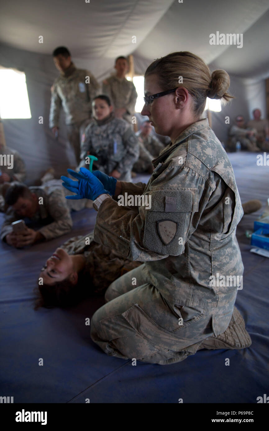 U.S. Army Sgt. Tiera Eldred prepares to insert a nasopharyngeal airway ...