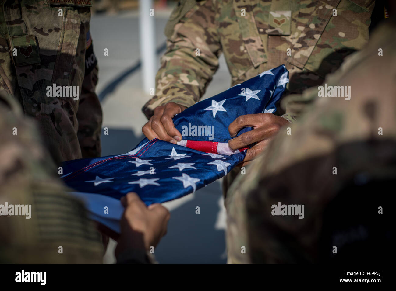 Members of the base Honor Guard team prepare to fold the flag during ...