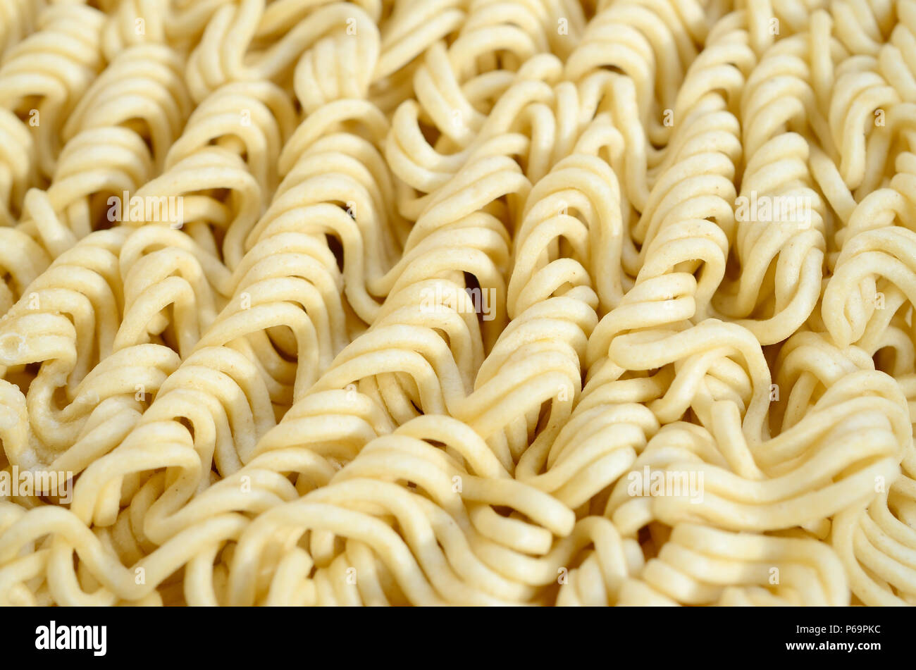 Close up view of yellow dry instant noodles. Chinese traditional food ...