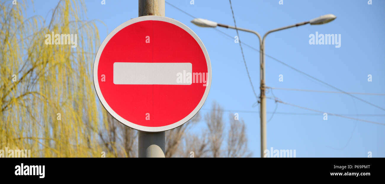 Road sign in the form of a white rectangle in a red circle. No entry ...