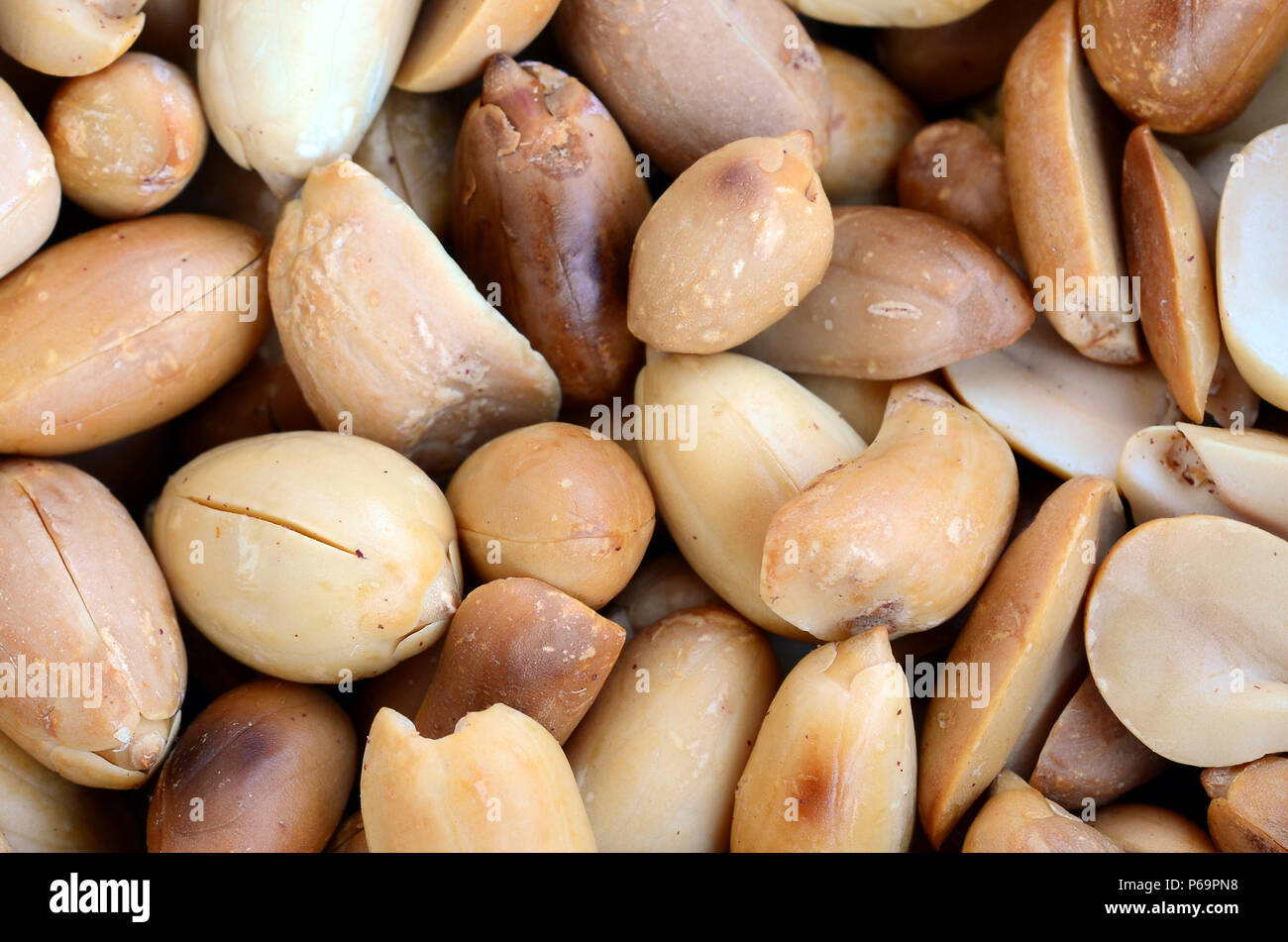 Peanut. A lot of small yellow nuts without peel. Background texture ...