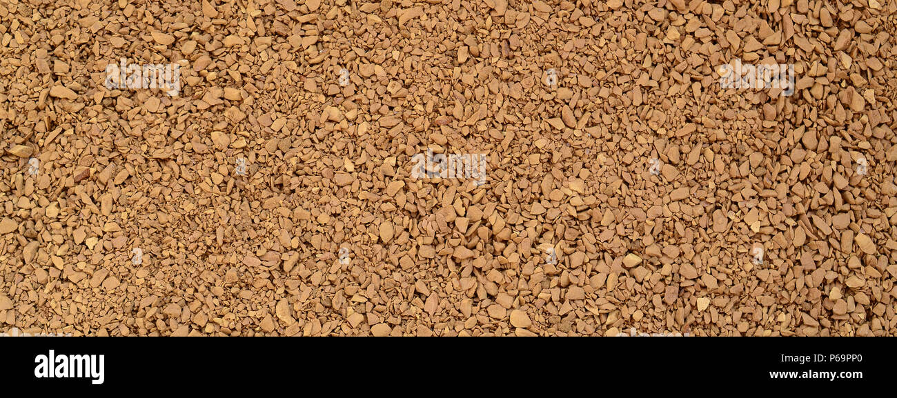 Texture of ground coffee in the form of many small pebbles of dark ...