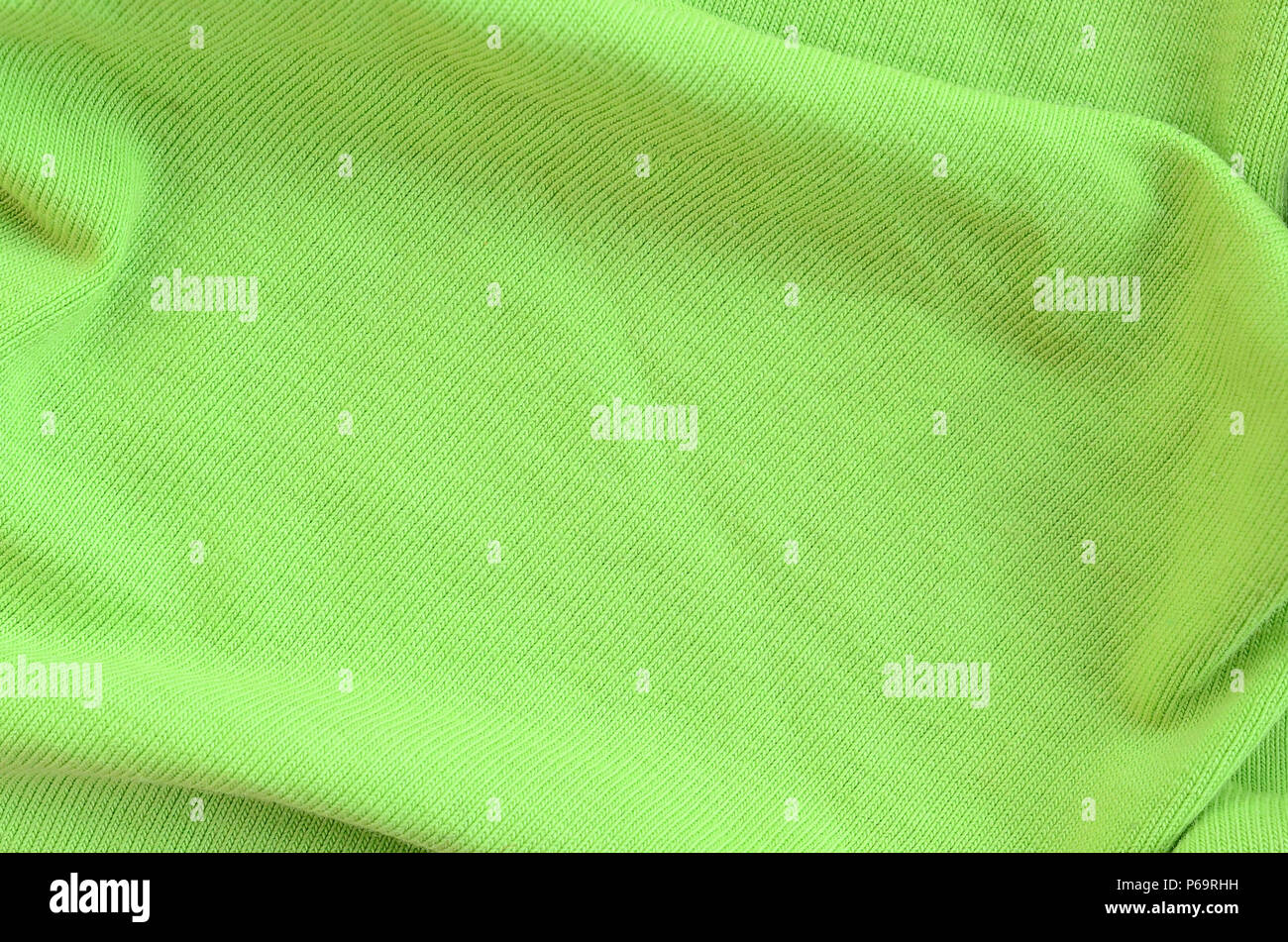 The texture of the fabric is bright green. Material for making shirts ...
