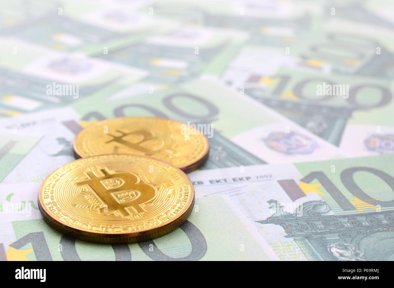 Golden physical bitcoins is lies on a set of green monetary ...