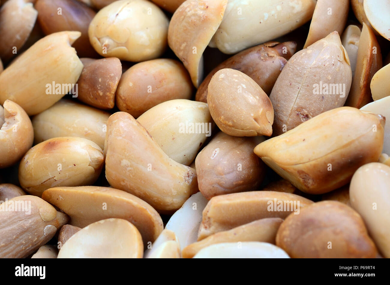 Peanut. A lot of small yellow nuts without peel. Background texture ...