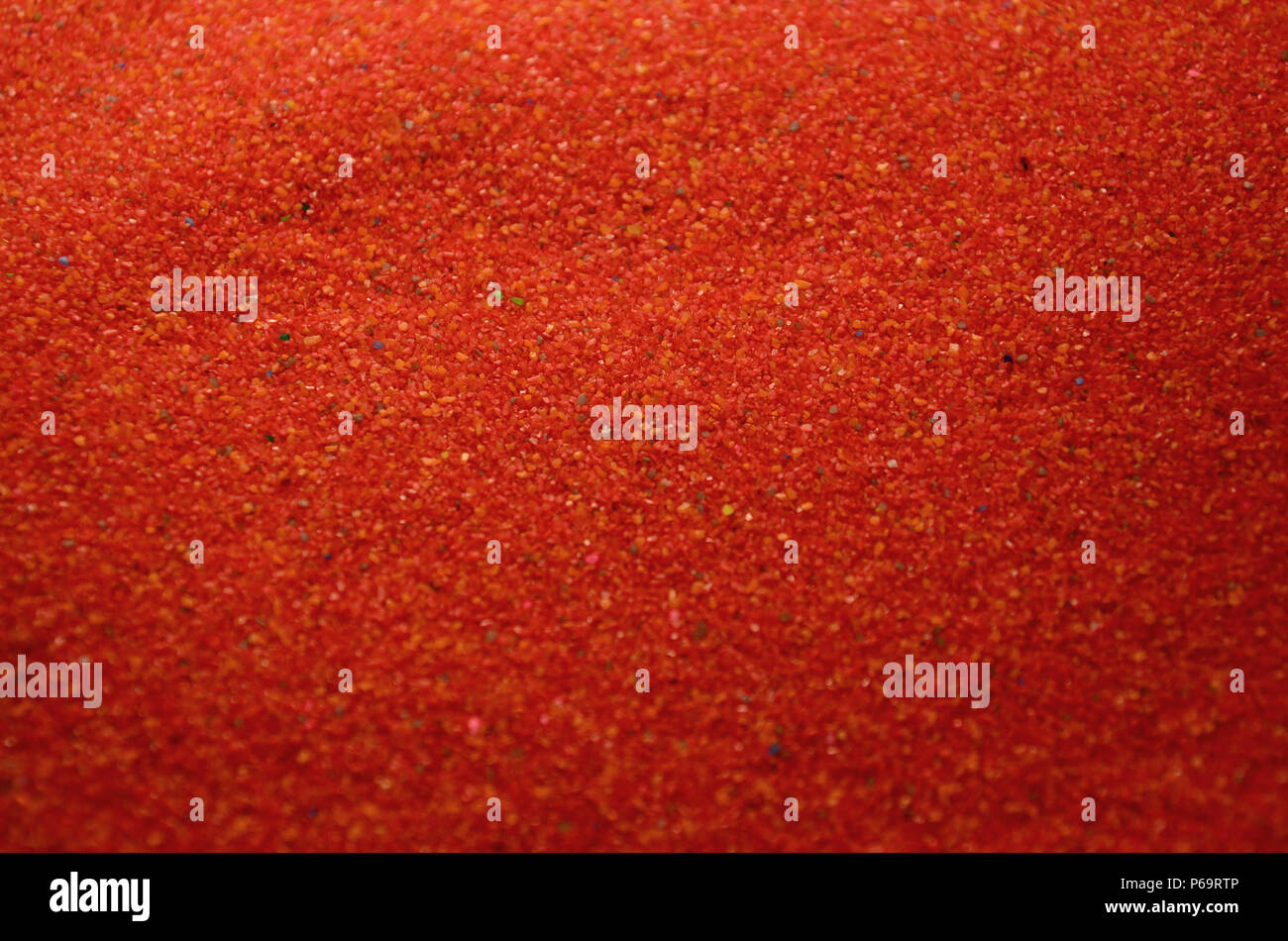 Texture of a colored granular sand close up. Red grains Stock Photo - Alamy