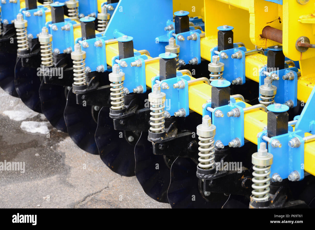 Spring system of agricultural seeder close up Stock Photo - Alamy