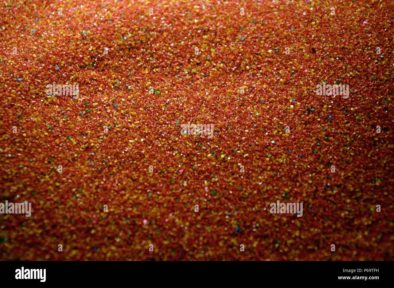 Texture of a colored granular sand close up. Red grains Stock Photo - Alamy