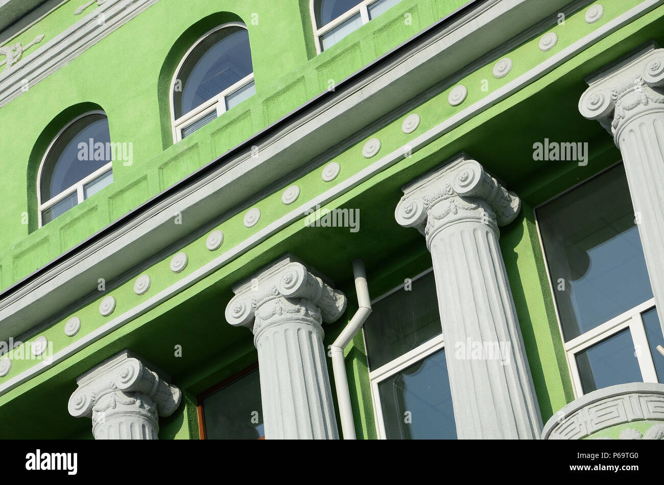 Restored old multi-storey building with antique columns, painted in ...