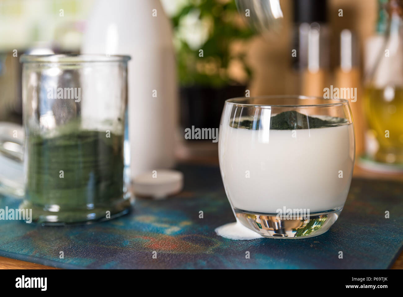 Closeup view fresh kefir probiotik drink in clear glass and spoon with ...