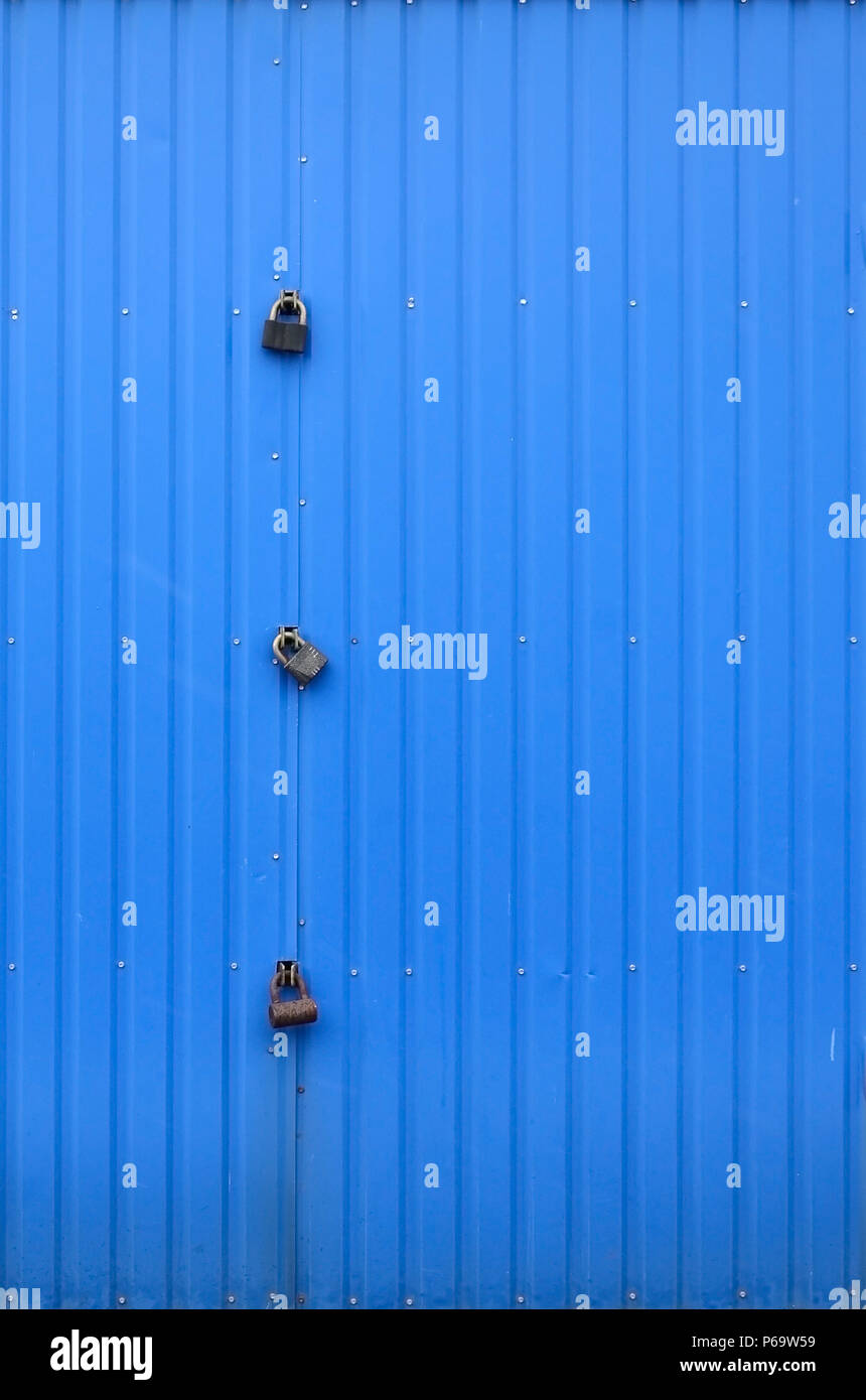 Texture of a metal blue wall with a gate closed for three locks Stock ...