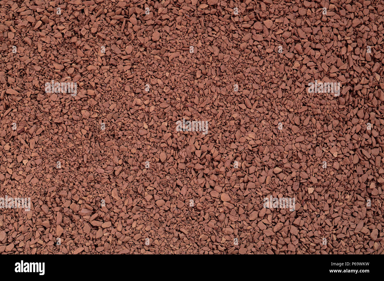 Texture of ground coffee in the form of many small pebbles of dark ...