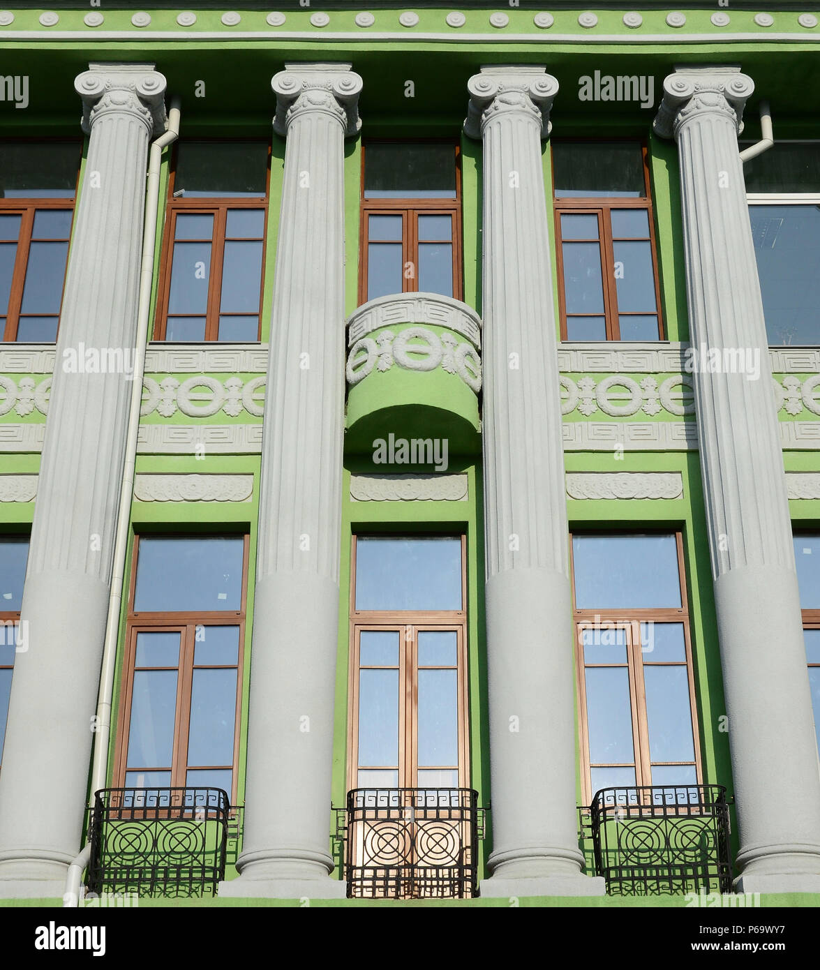 Restored old multi-storey building with antique columns, painted in ...