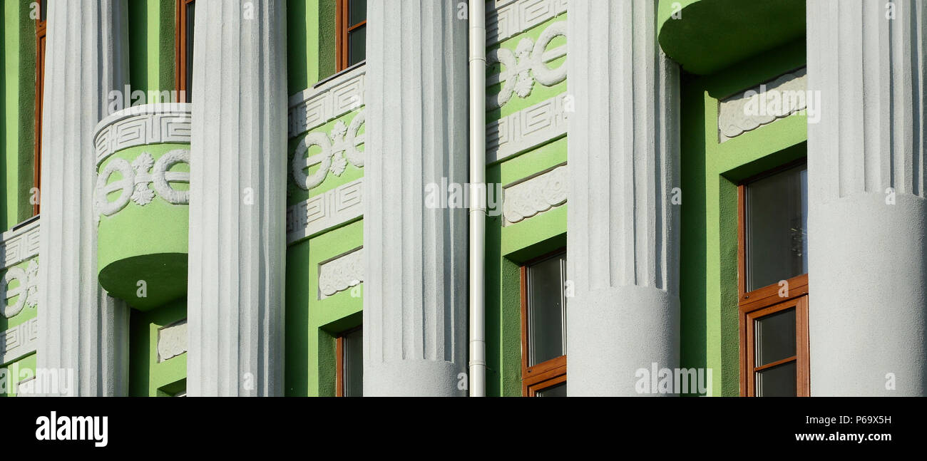 Restored old multi-storey building with antique columns, painted in ...