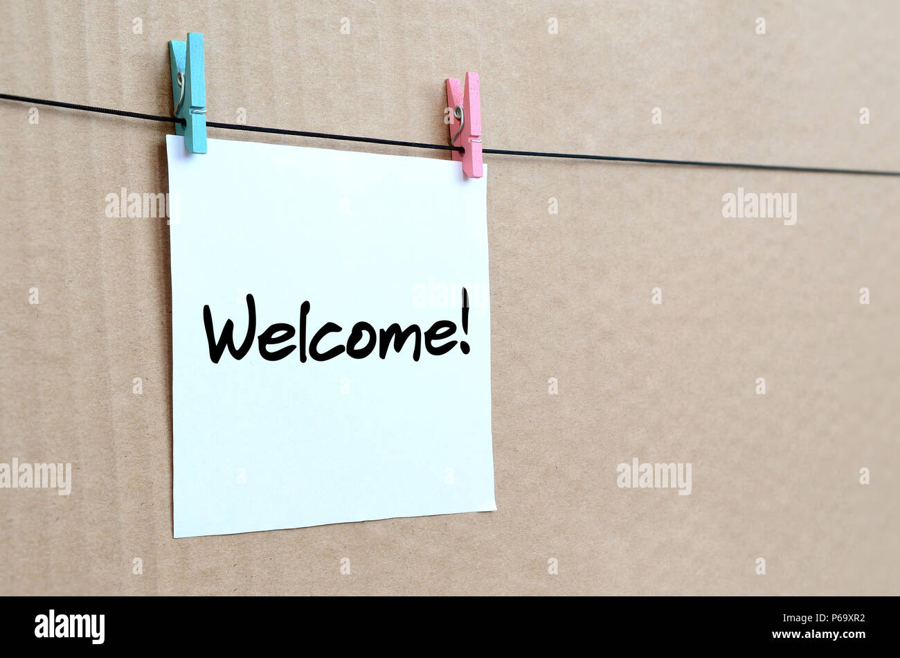 Welcome! Note is written on a white sticker that hangs with a ...