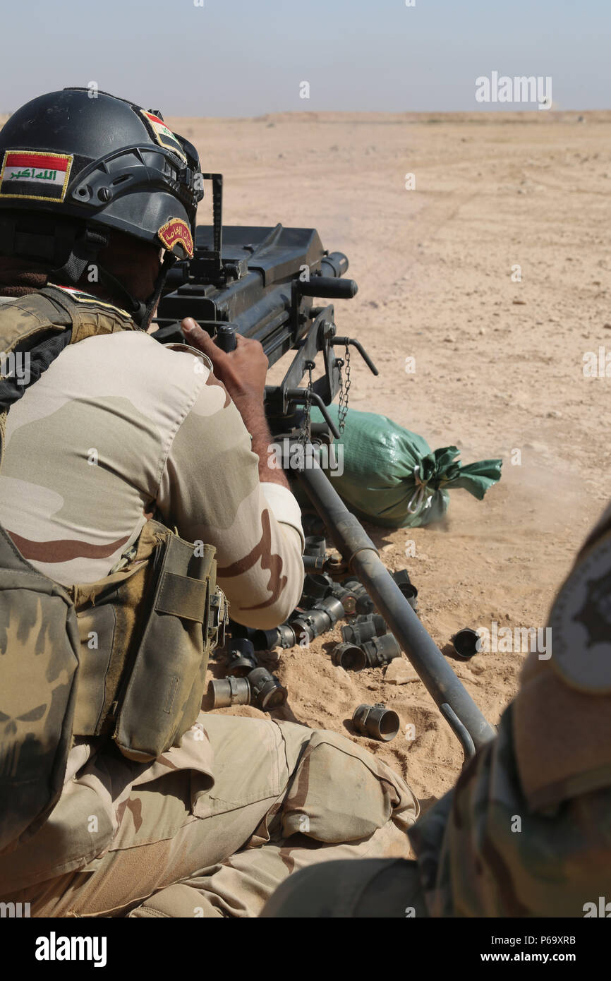 An Iraqi soldier, with the 7th Iraqi Army Division, fires a Mark 19 ...