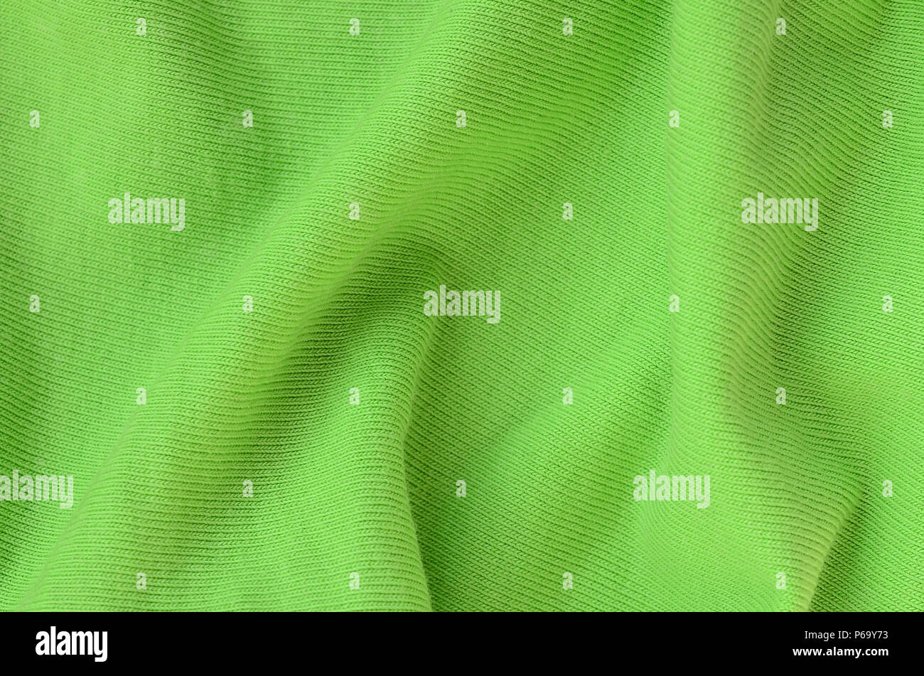 The texture of the fabric is bright green. Material for making shirts ...