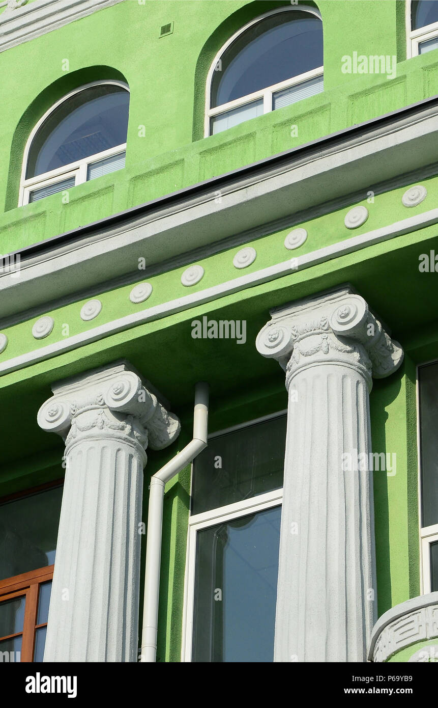 Restored old multi-storey building with antique columns, painted in ...