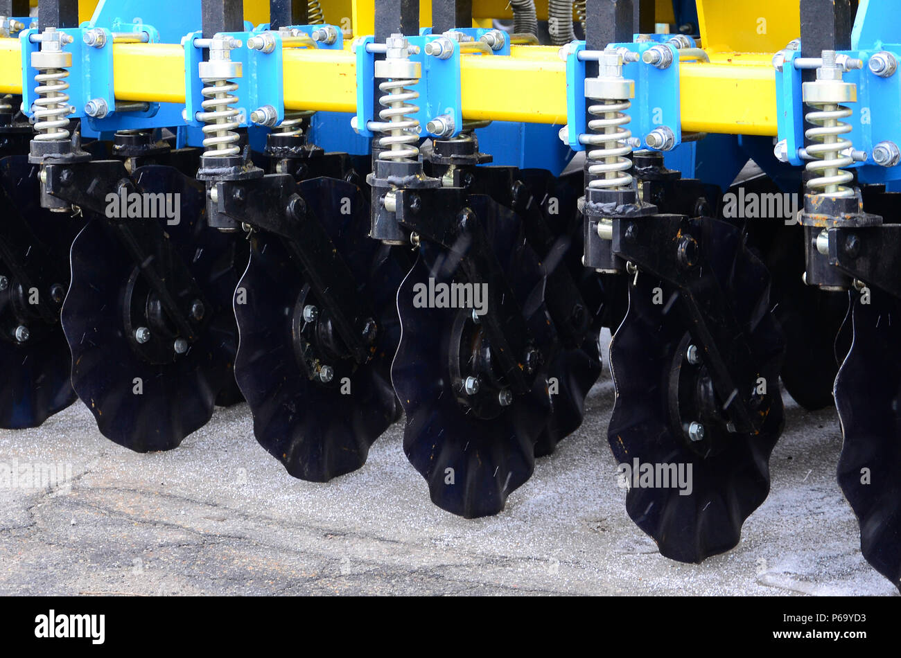 Spring system of agricultural seeder close up Stock Photo - Alamy