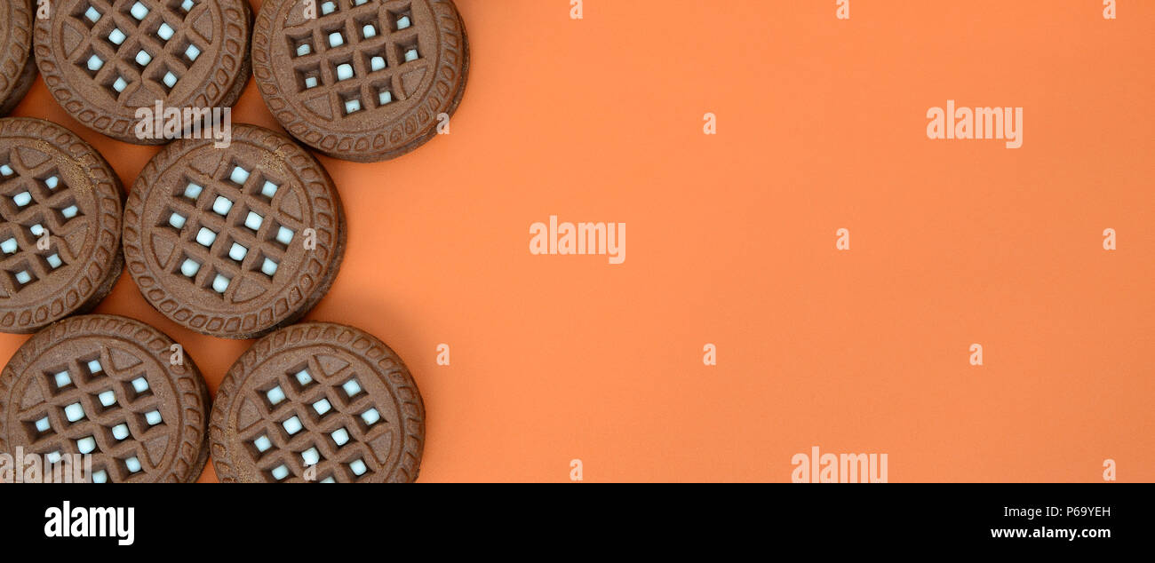 Detailed picture of dark brown round sandwich cookies with coconut ...