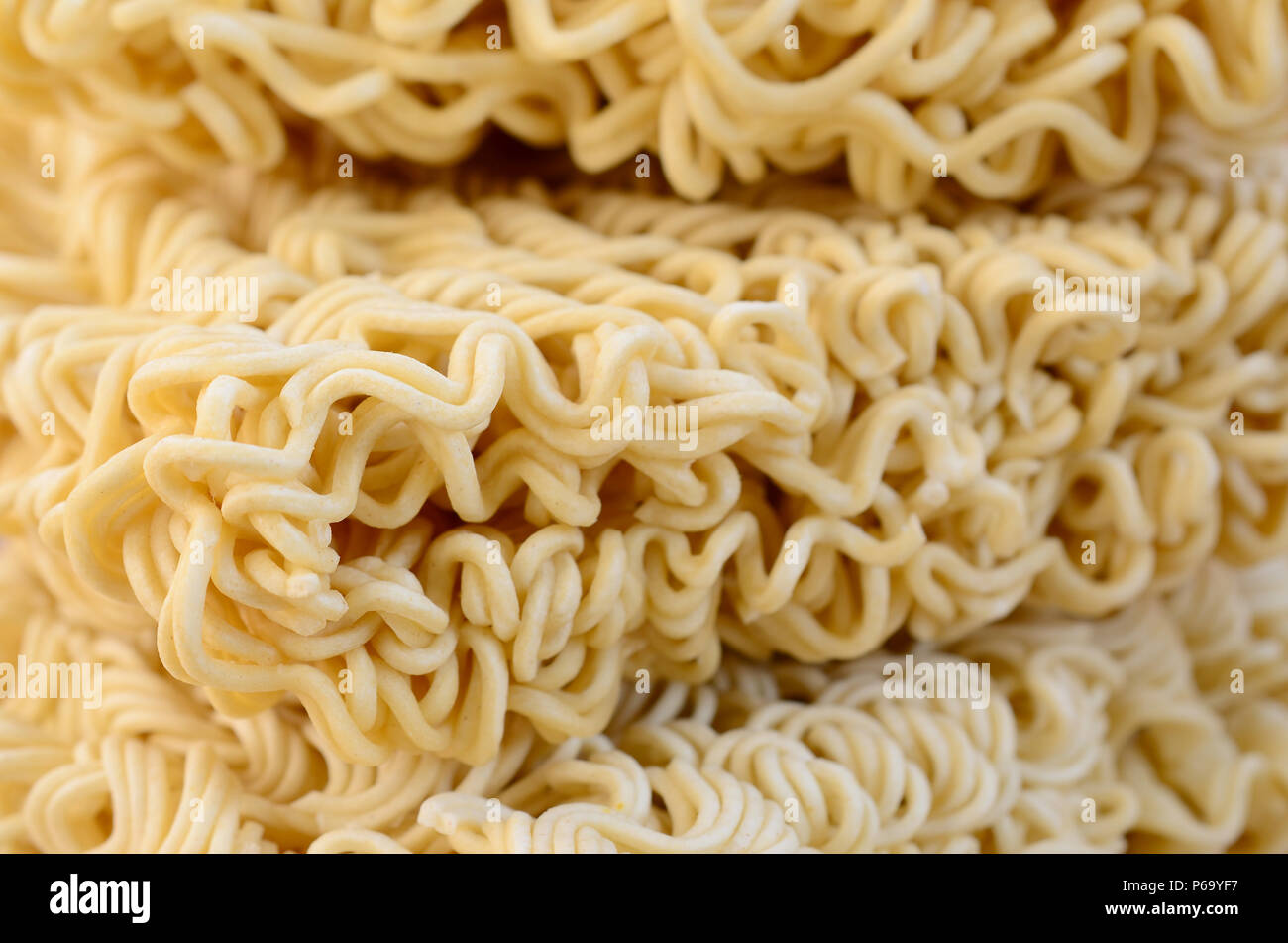 Close up view of yellow dry instant noodles. Chinese traditional food ...