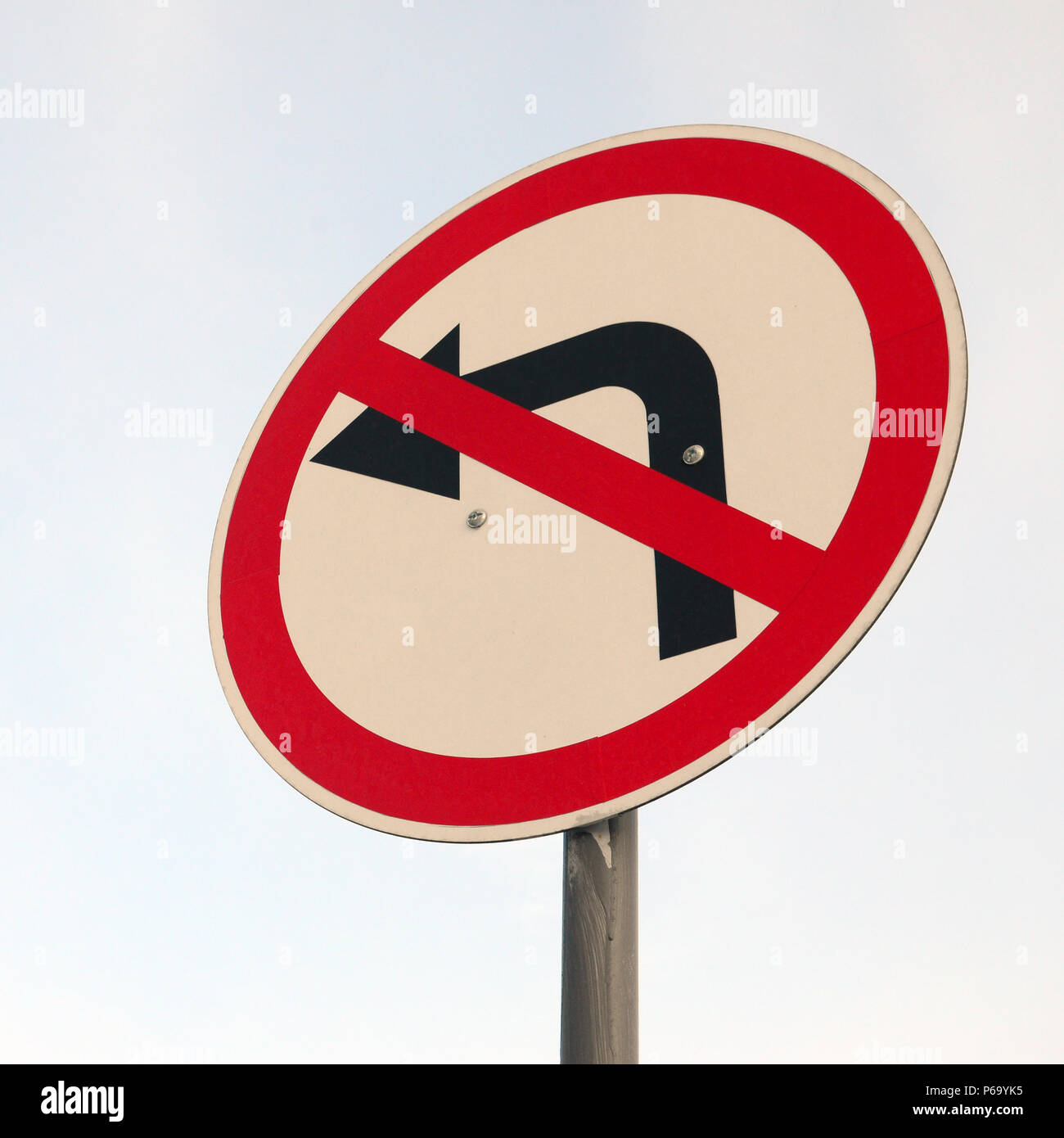 Turn left is prohibited. Traffic sign with crossed out arrow to the left Stock Photo - Alamy