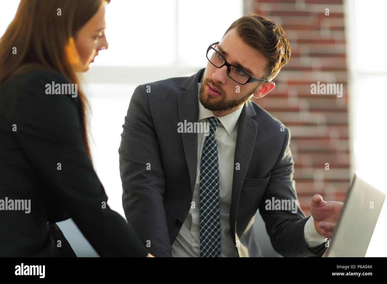 two coworkers discussing fun project over a laptop Stock Photo - Alamy