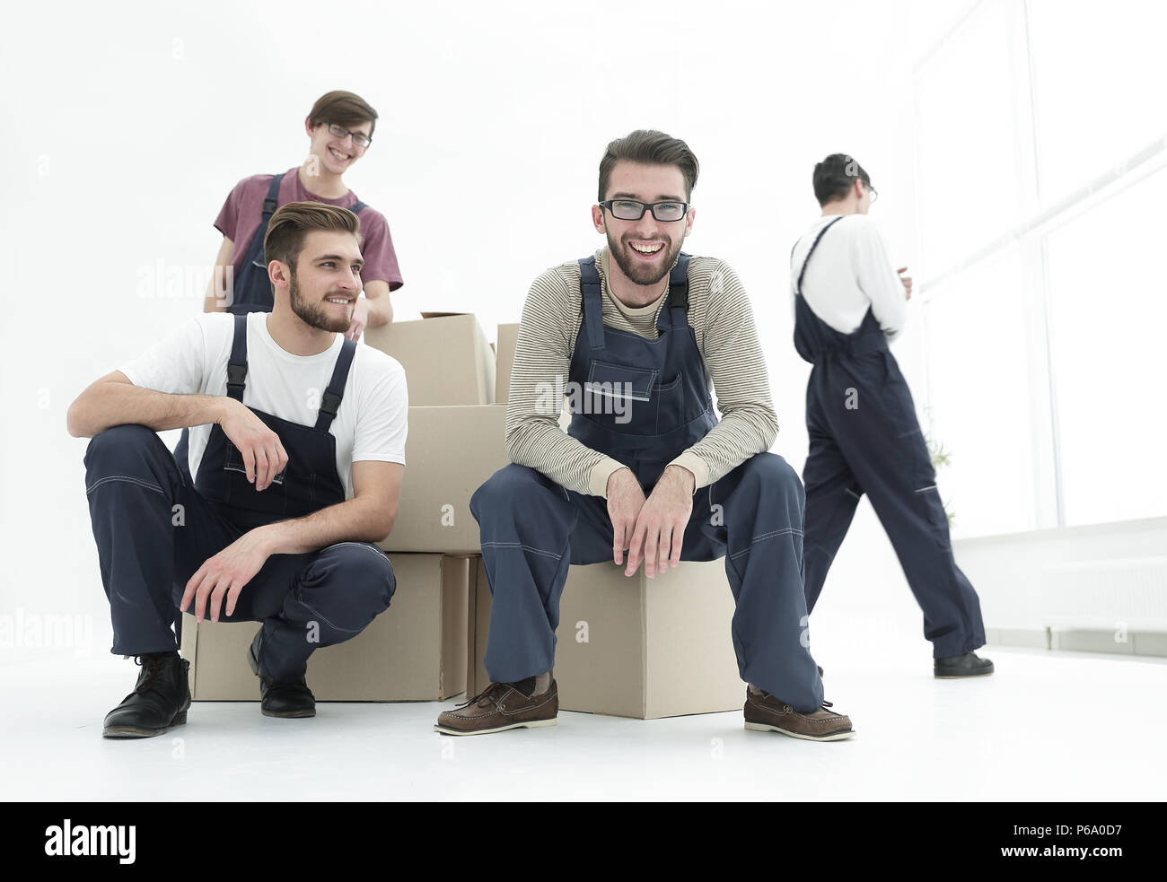 Men with stacked boxes isolated on white Stock Photo - Alamy