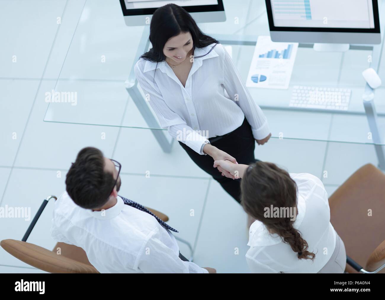 handshake manager and employee near the workplace Stock Photo - Alamy
