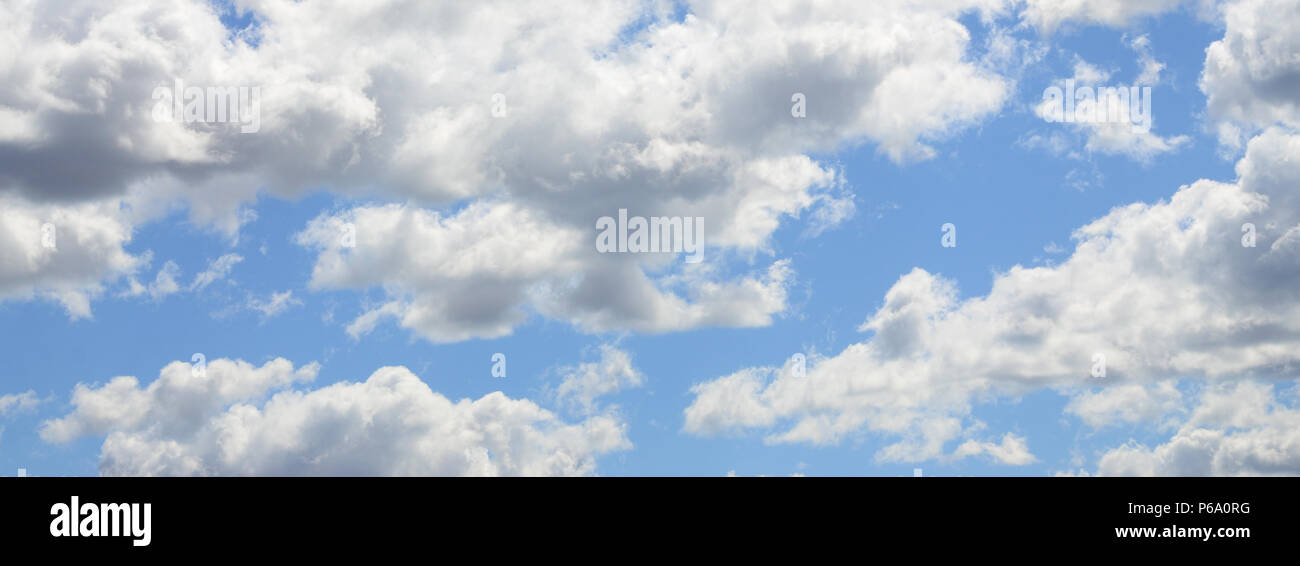 A blue sky with lots of white clouds of different sizes Stock Photo - Alamy